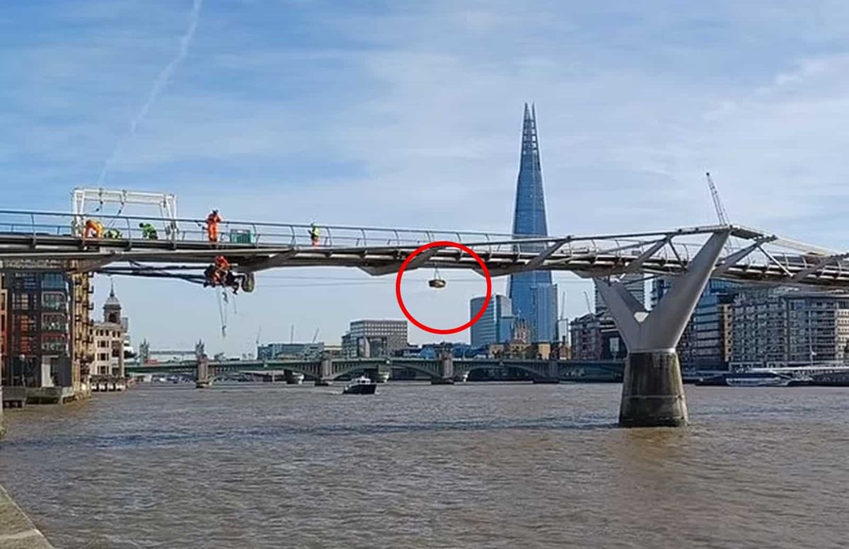 Millennium Bridge workers dangle bale of hay due to ancient by-law