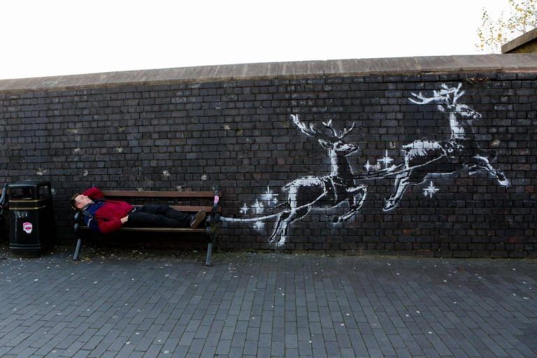 Mural of homeless man in reindeer sleigh is unveiled by Banksy to ...